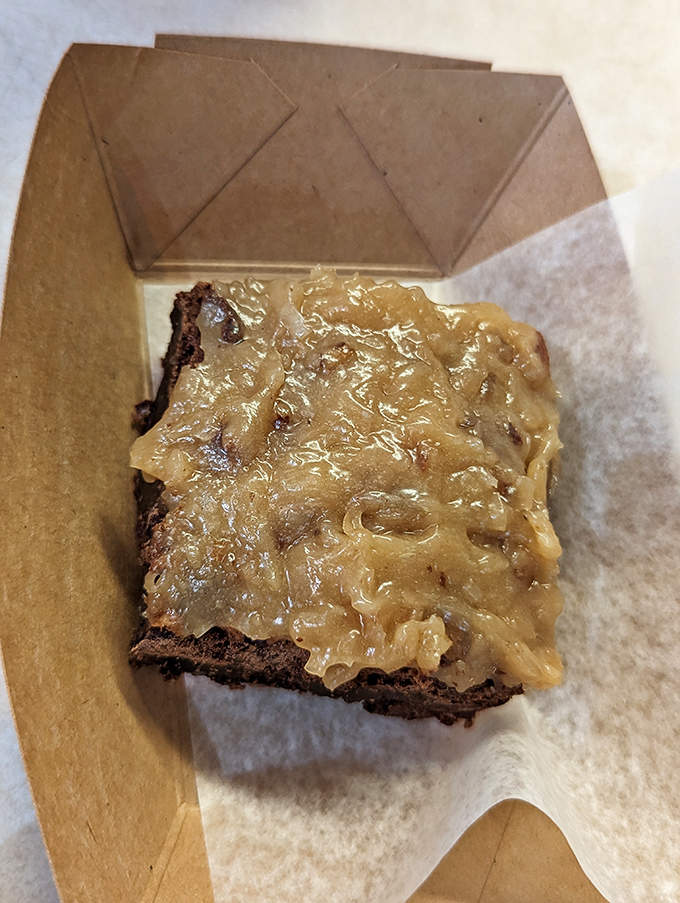 A brownie that doesn't need to show off with fancy plating. That gooey topping is speaking a universal language of dessert perfection.