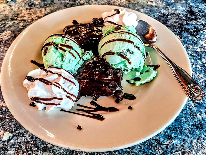 The brownie sundae that laughs in the face of moderation—mint ice cream and chocolate sauce creating a dessert worth every extra minute at the gym.