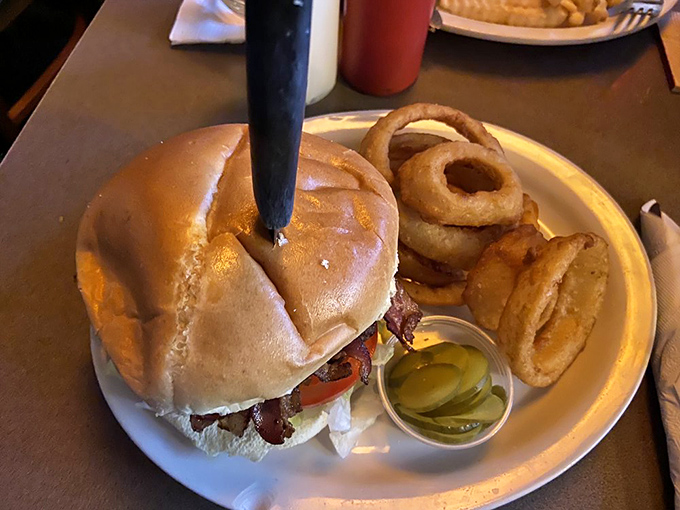 A proper tavern burger doesn't need to wear fancy clothes. This beauty, with its golden bun and pickle sidekick, understands the assignment perfectly.