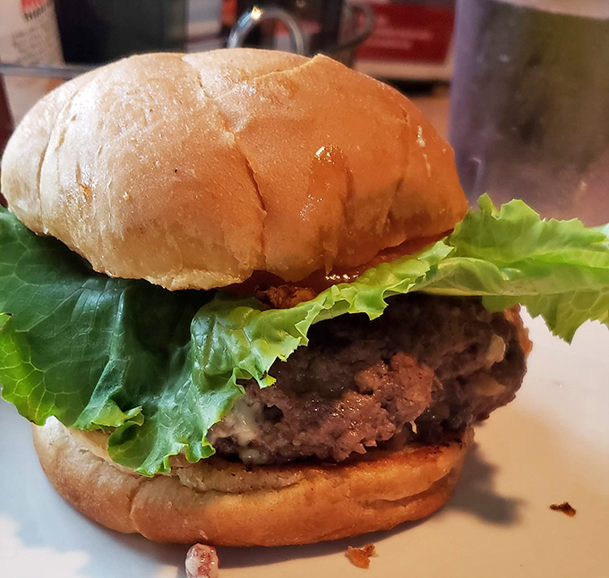 A burger that means business, dressed simply with crisp lettuce on a pillowy bun. No pretension, no gimmicks—just honest-to-goodness satisfaction between two slices of bread.