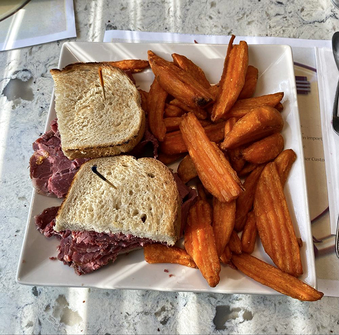 This club sandwich towers with architectural precision that Frank Lloyd Wright would surely appreciate.