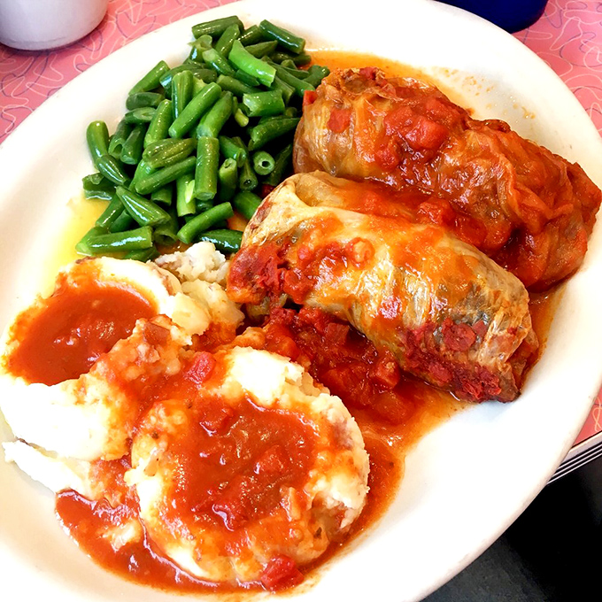 These cabbage rolls aren't just dinner &ndash; they're edible history, swimming in tangy tomato sauce alongside mashed potatoes that could make a grown person weep.