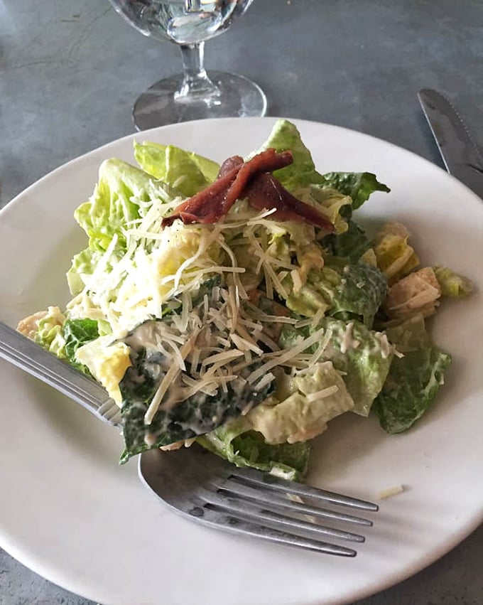 A Caesar salad that Julius himself would approve&mdash;crisp romaine, proper dressing, and those little anchovy whispers that make it authentic.