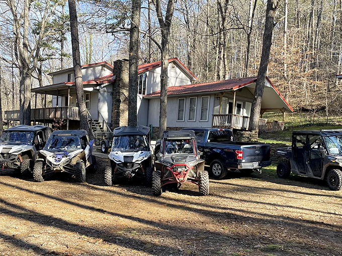 Rustic accommodations near the byway welcome outdoor enthusiasts, with a lineup of ATVs suggesting the day's adventures are far from over.