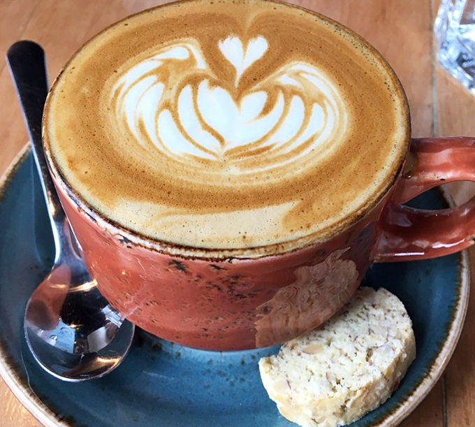 Coffee art so pretty you almost don't want to drink it. Almost. That little shortbread cookie is the sidekick every latte deserves.
