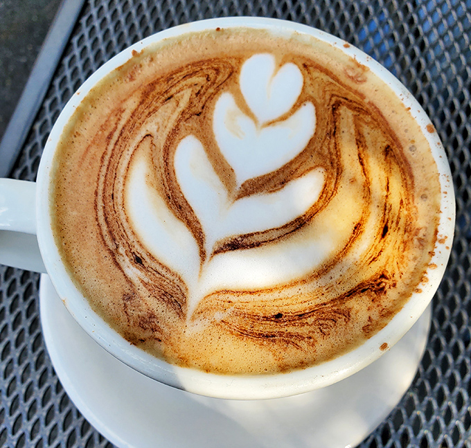 Latte art that's almost too pretty to drink. Almost. This leaf design proves coffee can be both craft and comfort.