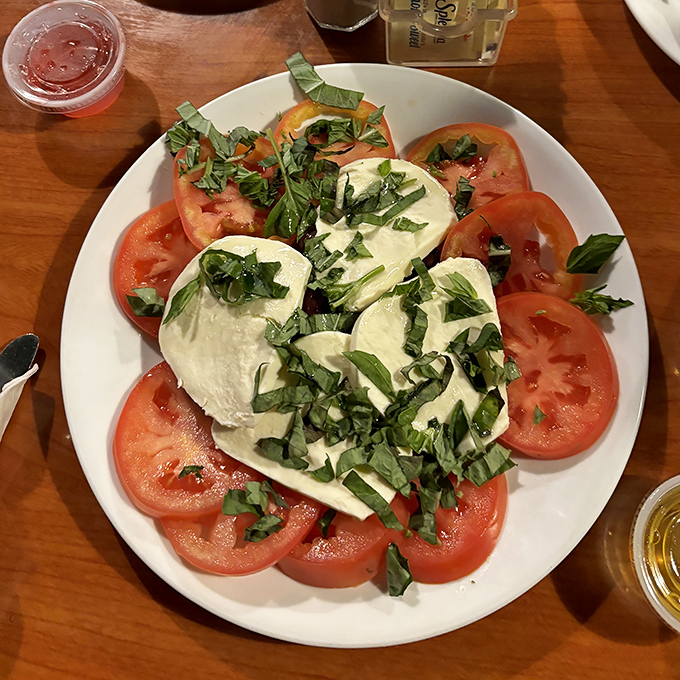 Fresh mozzarella and tomatoes sprinkled with basil&mdash;proof that sometimes the simplest combinations create the most profound flavors.