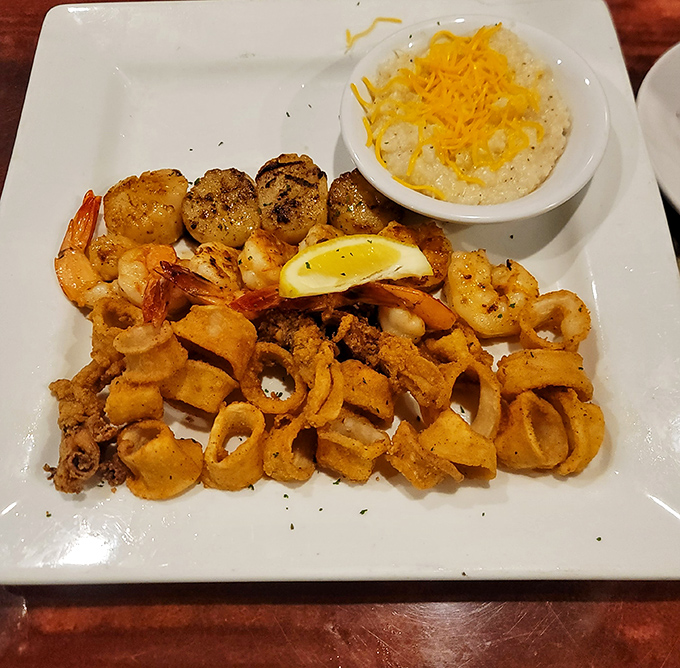 A seafood trinity of perfectly prepared shrimp, calamari, and fish with grits that would make any Southern grandmother nod in approval.