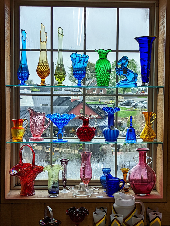Sunlight transforms this carnival glass display into a kaleidoscope of blues and reds&mdash;each piece holding memories of county fairs past.