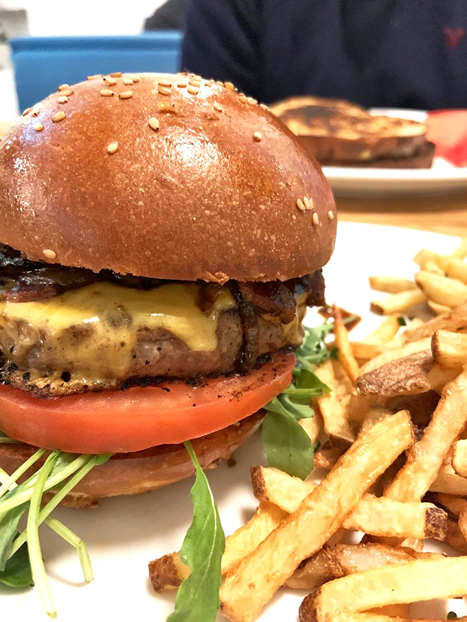 A burger so perfectly constructed it deserves its own blueprint. The cheese melt cascades like a yellow waterfall of deliciousness.