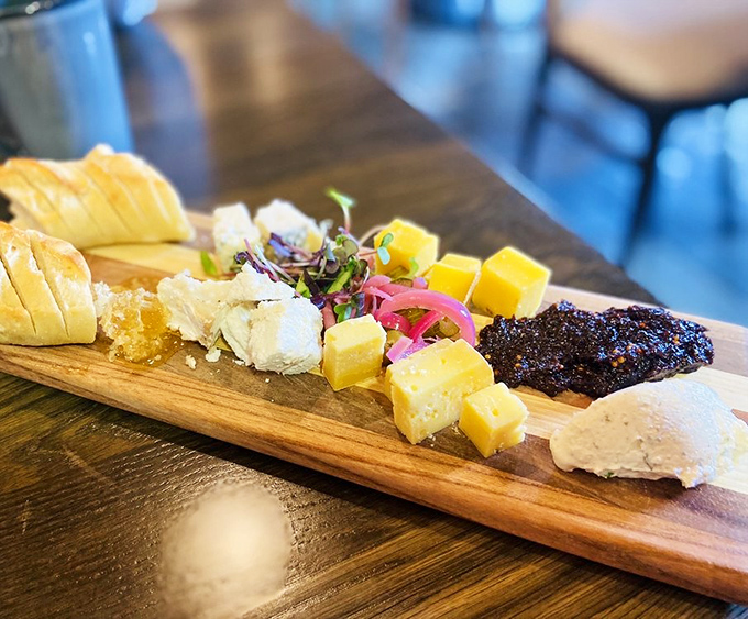 A cheese board that deserves its own ZIP code. This wooden plank of dairy perfection is what happens when cows live their best lives.
