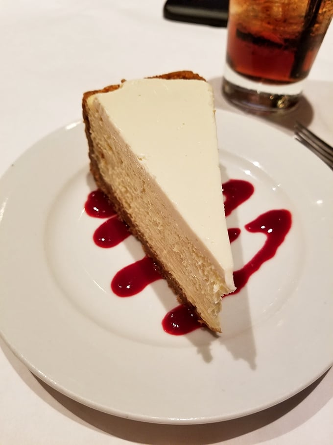 Cheesecake that achieves that mythical balance between dense and light, with berry sauce artfully applied like edible calligraphy. Dessert as performance art.