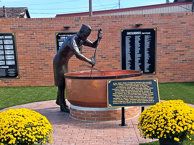 This bronze cheesemaker eternally stirs his copper kettle, a testament to the Swiss immigrants who brought their dairy wizardry to America's heartland.