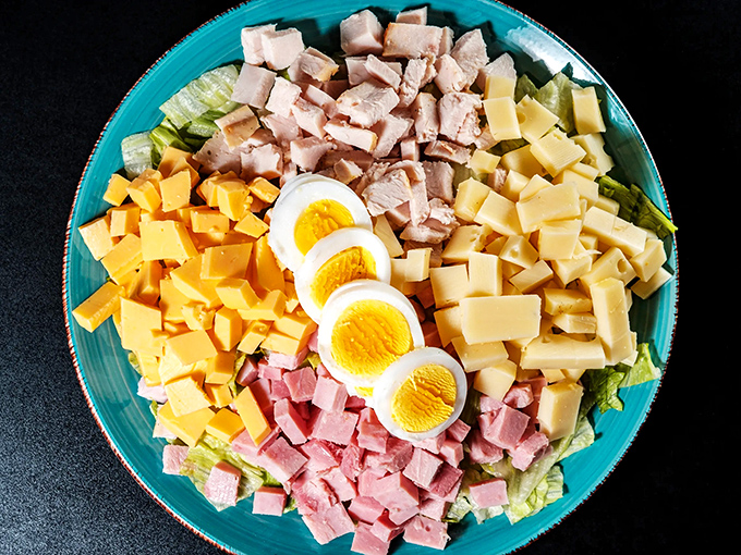A chef salad arranged with the precision of a Renaissance painting. When vegetables, proteins, and eggs come together in such harmony, even salad skeptics become believers.