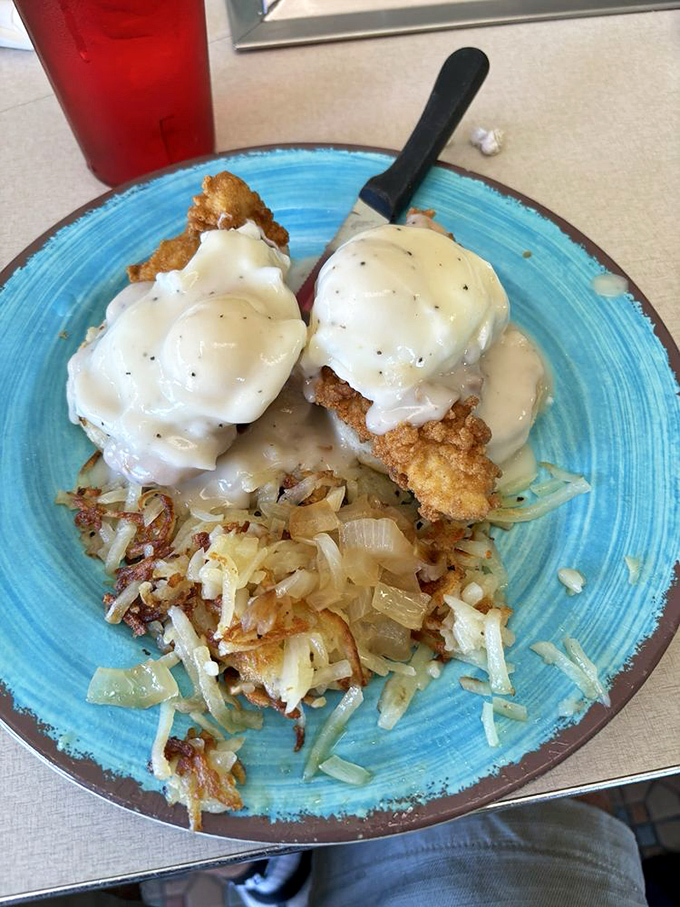 Chicken eggs Benedict that redefines decadence &ndash; crispy fried chicken beneath poached eggs and hollandaise that cascades like a savory waterfall.