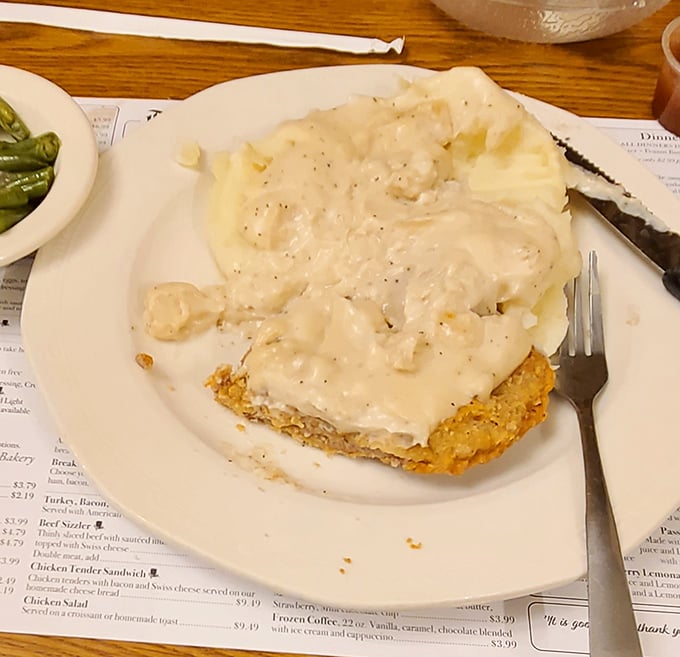 Chicken fried steak smothered in gravy with a side of mashed potatoes—because sometimes you need carbs with your carbs. No regrets.