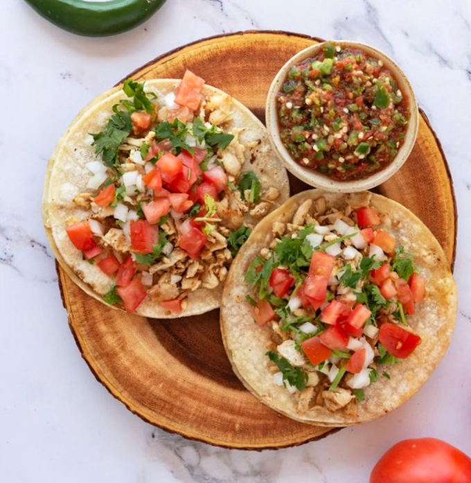 Street tacos that transport you straight to flavor country. Fresh, vibrant, and topped with enough cilantro to spark the age-old debate: divine herb or soapy menace?