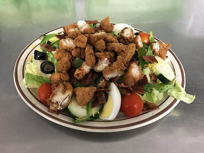 A salad that doesn't apologize for being a salad. Those crispy chicken tenders are like tasty lifeguards making sure no one drowns in healthiness.