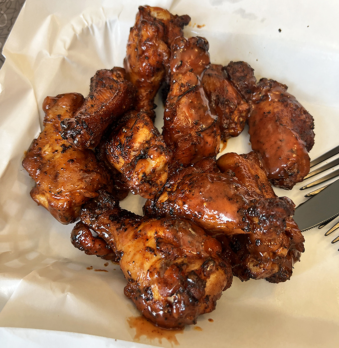 These chicken wings have clearly been initiated into the smoke society&mdash;glistening with sauce and bearing the marks of their delicious transformation.
