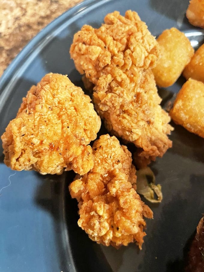 Golden-fried chicken bites that could make a vegetarian weep with temptation. The exterior crunch gives way to juicy tenderness that defies fast-casual expectations.