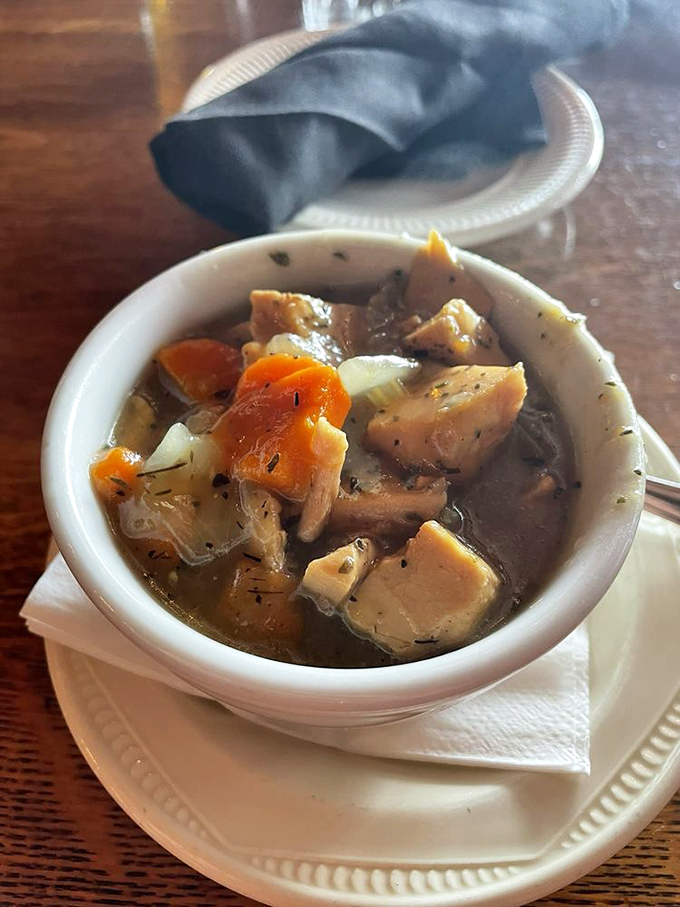 A bowl of homemade soup that proves comfort doesn't need to be complicated. Chunks of chicken, vegetables, and herbs swimming in broth that tastes like someone's grandmother supervised its creation.