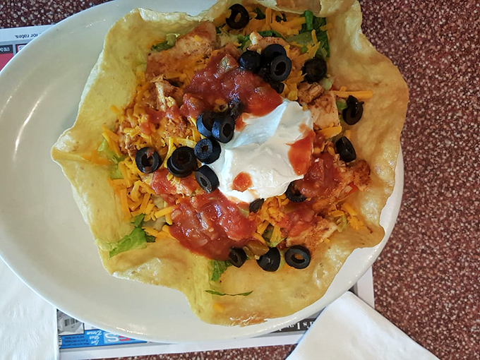 This taco salad bowl isn't just lunch&mdash;it's edible architecture, a crispy fortress protecting a kingdom of cheese, olives, and seasoned protein.