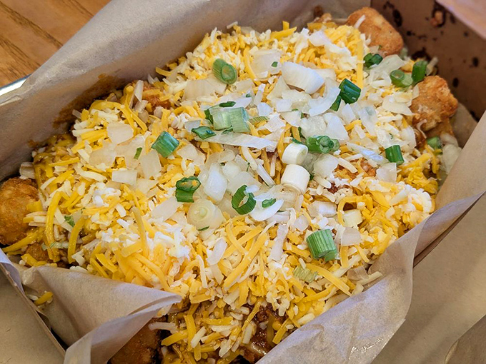 Chili cheese tater tots: where comfort food goes to show off, wearing a coat of melted cheddar and green onions like edible jewelry.