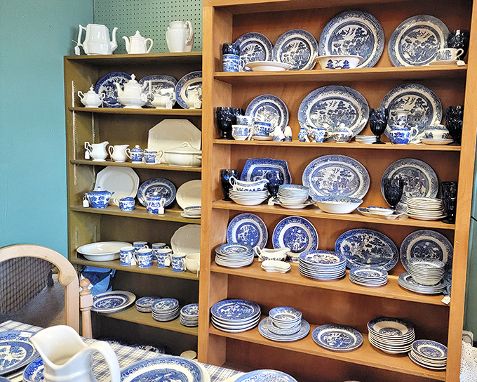 Blue willow patterns dance across shelves like a porcelain ballet from dining rooms of yesteryear.