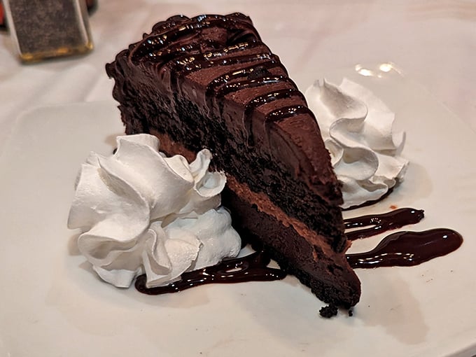 A chocolate cake so decadent it makes grown adults contemplate licking the plate when no one's looking.