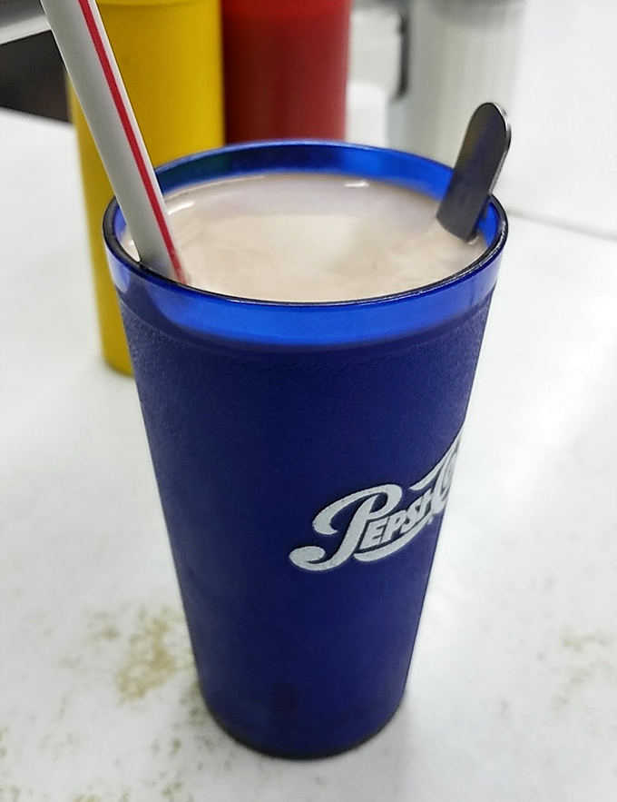 The blue Pepsi cup isn't just holding a milkshake; it's cradling liquid happiness thick enough to warrant that sturdy straw standing at attention.