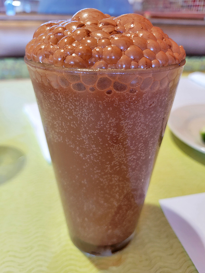 This chocolate milkshake isn't just thick—it's contemplating a career change to become pudding. The bubble top is nature's way of saying "good luck with that straw."