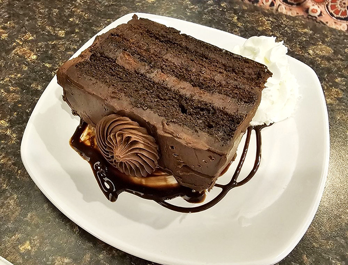 A chocolate cake so serious about its mission, it arrives with its own backup dancer of whipped cream. Resistance is futile.