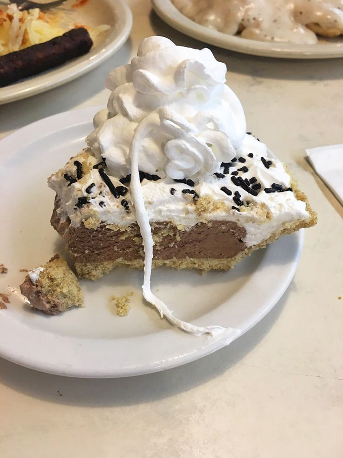 A slice of chocolate cream pie topped with a mountain of whipped cream&mdash;because sometimes more is exactly the right amount.