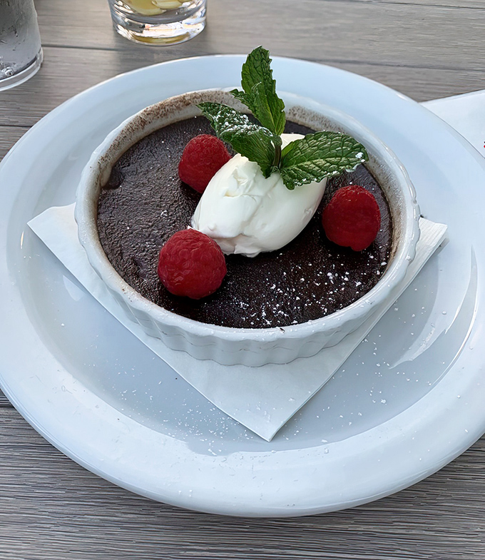 Chocolate pot de cr&egrave;me with raspberries: proof that after a seafood feast, the sweet finale deserves equal billing in your food memories.