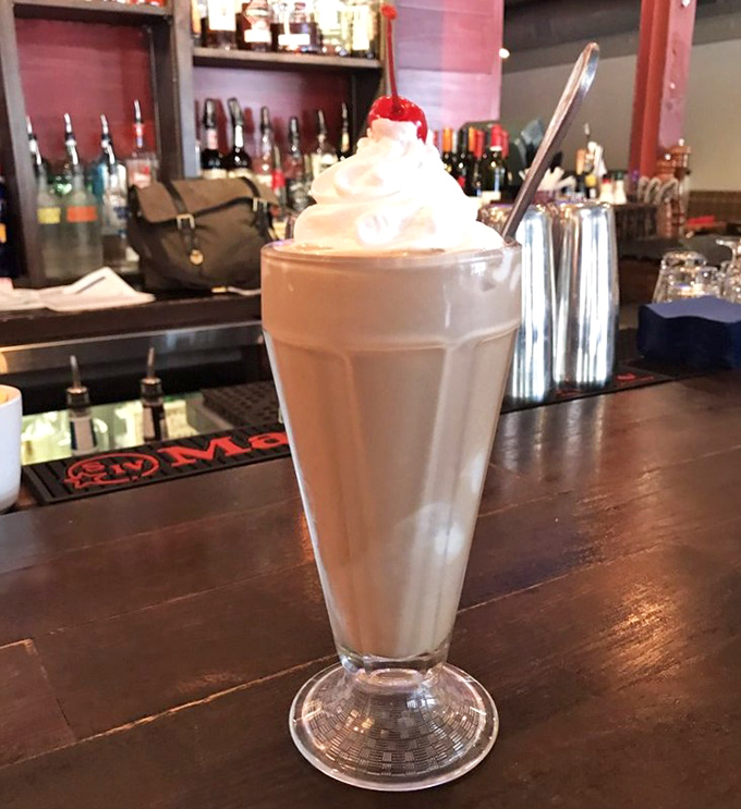 This towering milkshake could double as dessert and a meal, crowned with whipped cream and pure indulgence.