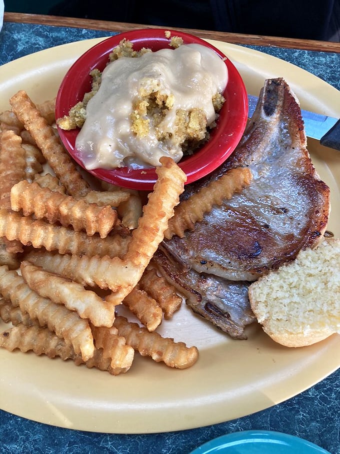 Pork chop perfection meets crinkle-cut fries in a plate symphony that makes you wonder why you'd ever need fancy dining again.