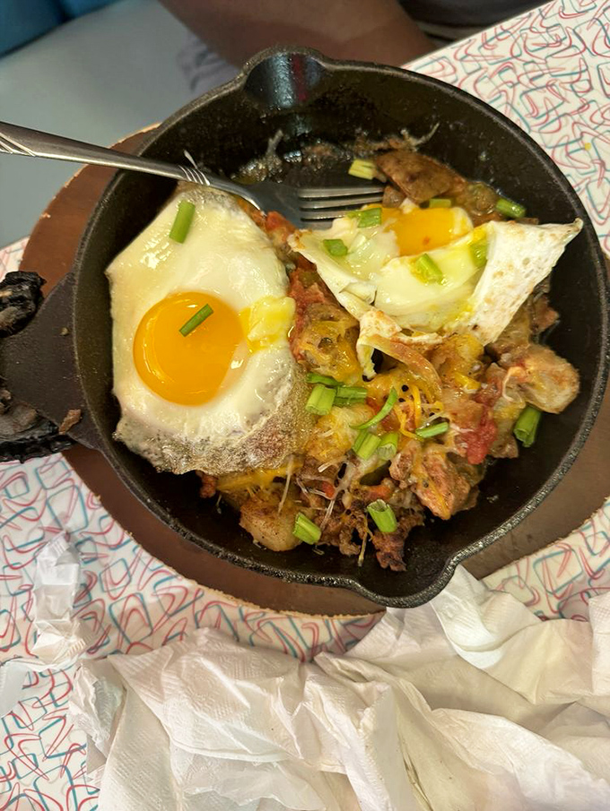 That sizzling skillet arrives like a rockstar on stage&mdash;eggs sunny-side up crowning a spicy fiesta underneath.