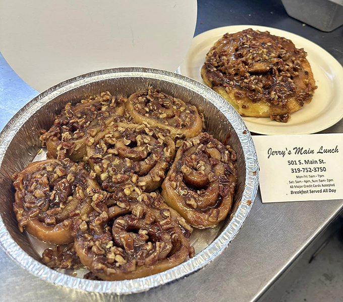 These aren't just cinnamon rolls; they're spiral-shaped happiness topped with enough pecans to make a squirrel consider breaking and entering.