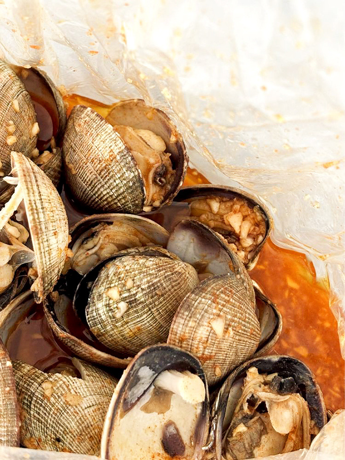 These clams have opened up to share their secrets with a spicy sauce that's worth every napkin you'll need afterward.