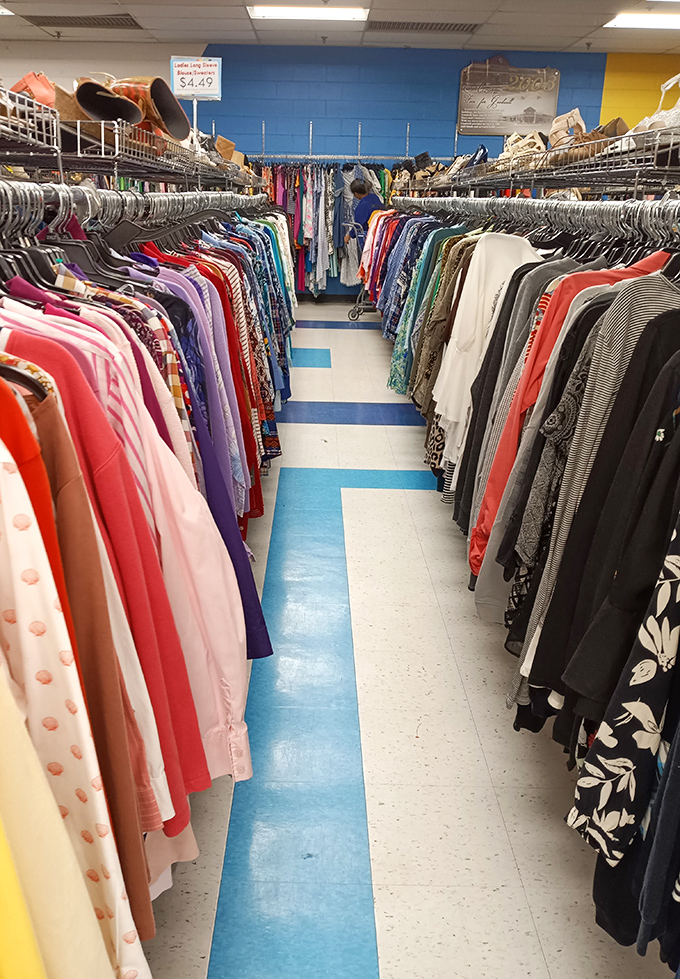Treasure hunters navigate the rainbow sea of garments at Triad Goodwill, where yesterday's fashion finds new admirers and every aisle promises discovery.