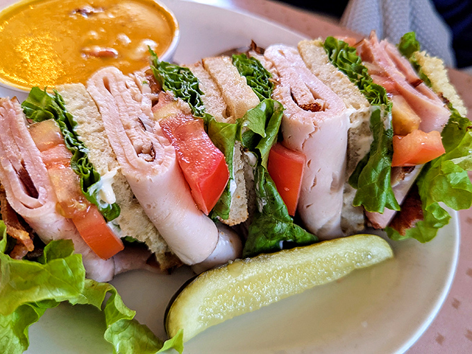 This club sandwich stands tall and proud, layered like a delicious skyscraper ready for demolition by fork.