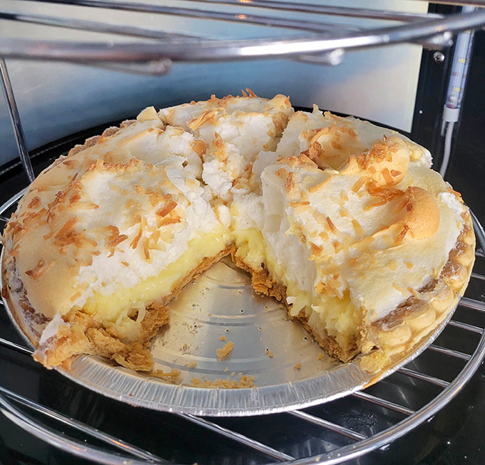 Coconut meringue pie with a mile-high crown of toasted fluff&mdash;the kind of dessert that makes you consider ordering a second slice before finishing the first.