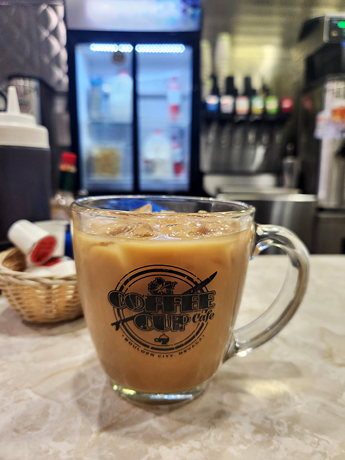 The Coffee Cup's signature mug filled with what appears to be liquid motivation. Coffee so good they put their name right on the vessel.