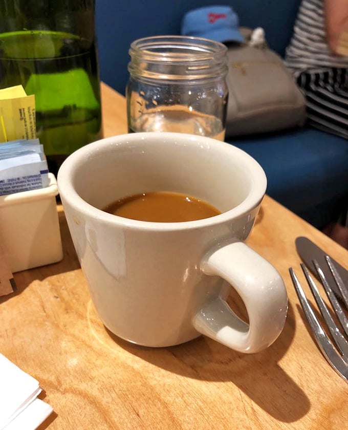 Simple pleasures: a perfect cup of coffee on a wooden table&mdash;the unsung hero of every great breakfast experience.