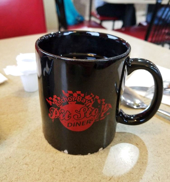 That black mug isn't just holding coffee&mdash;it's cradling liquid motivation with the diner's logo reminding you where to return tomorrow.