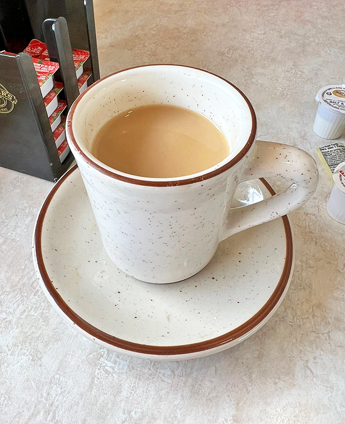 The humble diner coffee cup – civilization's most perfect vessel. This isn't some fancy pour-over, it's the reliable companion that gets Illinois moving every morning.