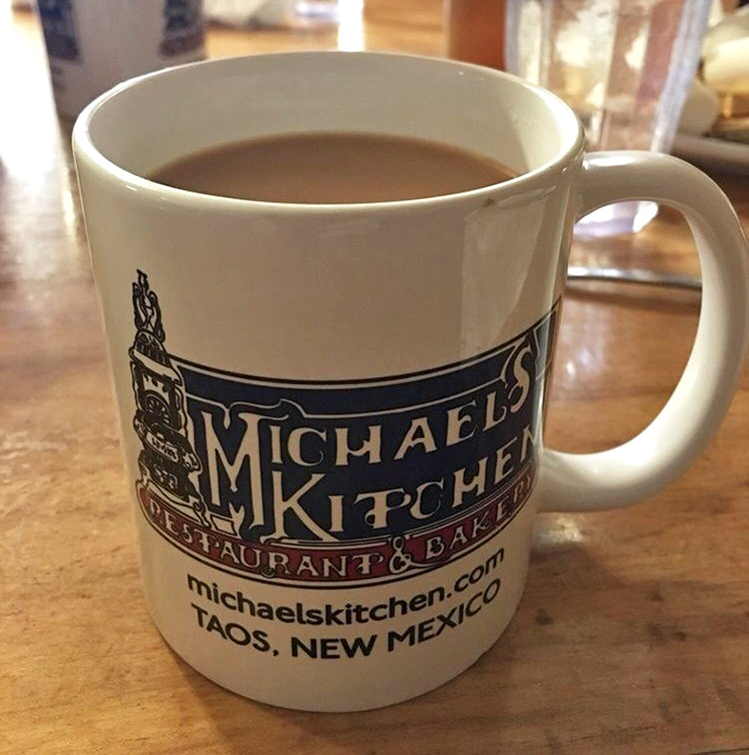 A mug of coffee bearing the Michael's Kitchen logo &ndash; your trusty companion through a breakfast adventure that requires proper caffeination.