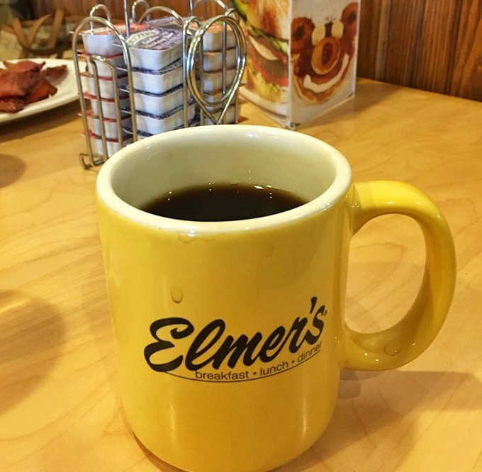 The cheerful yellow mug isn't just serving coffee; it's offering liquid motivation to face the day with a smile.