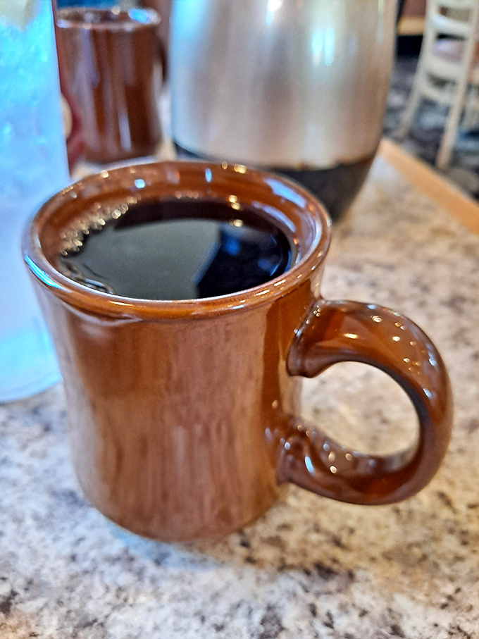 Even the coffee comes in those nostalgic brown mugs that somehow make everything taste better, like drinking from a memory.