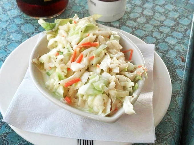 Even the coleslaw gets the VIP treatment at Kyma - crisp, fresh, and ready to cut through the richness of your seafood feast.